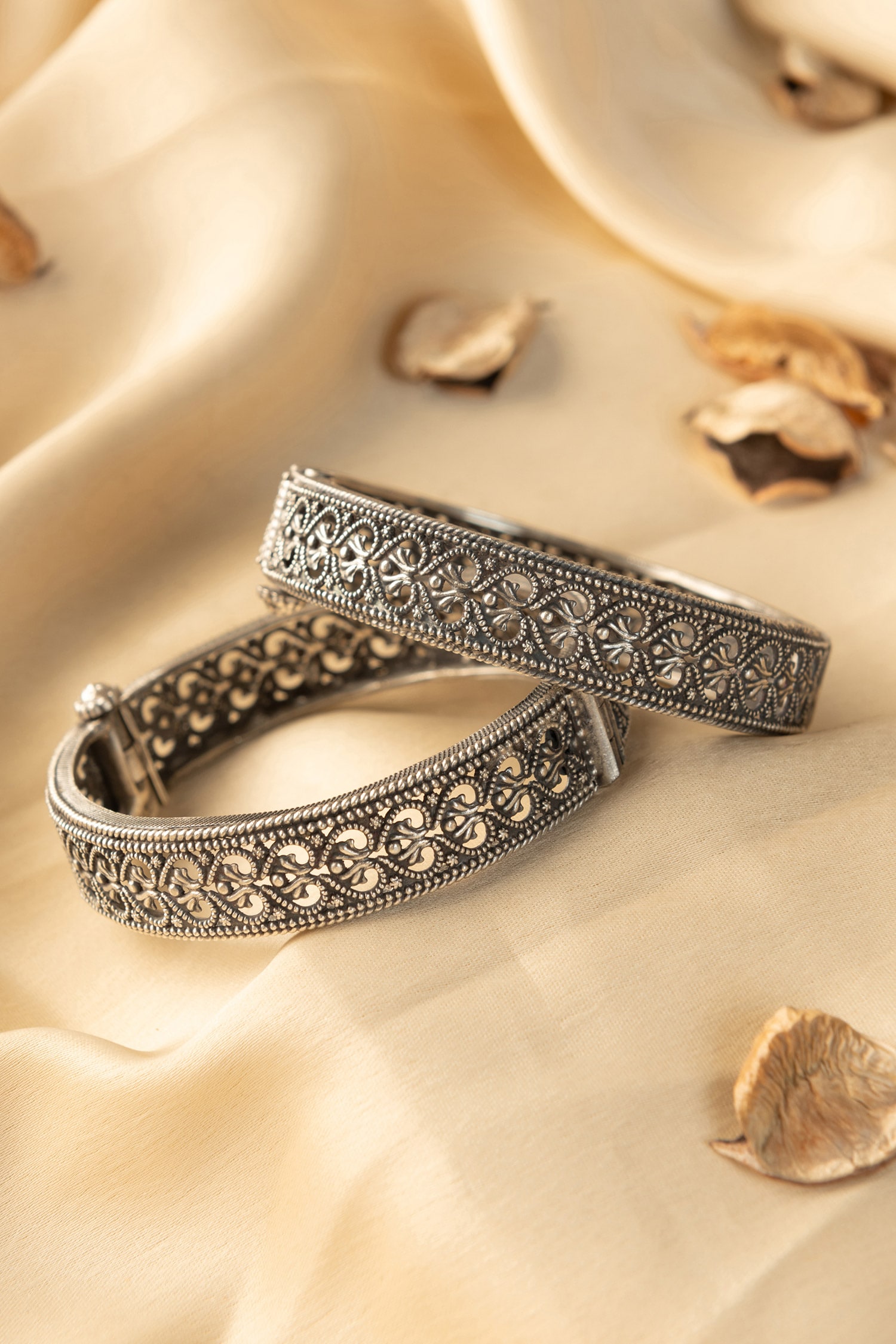 Buy Silver Plated Temple Paisley Carved Bangle 2 Pcs Set by Mero Jewellery Online at Aza Fashions.