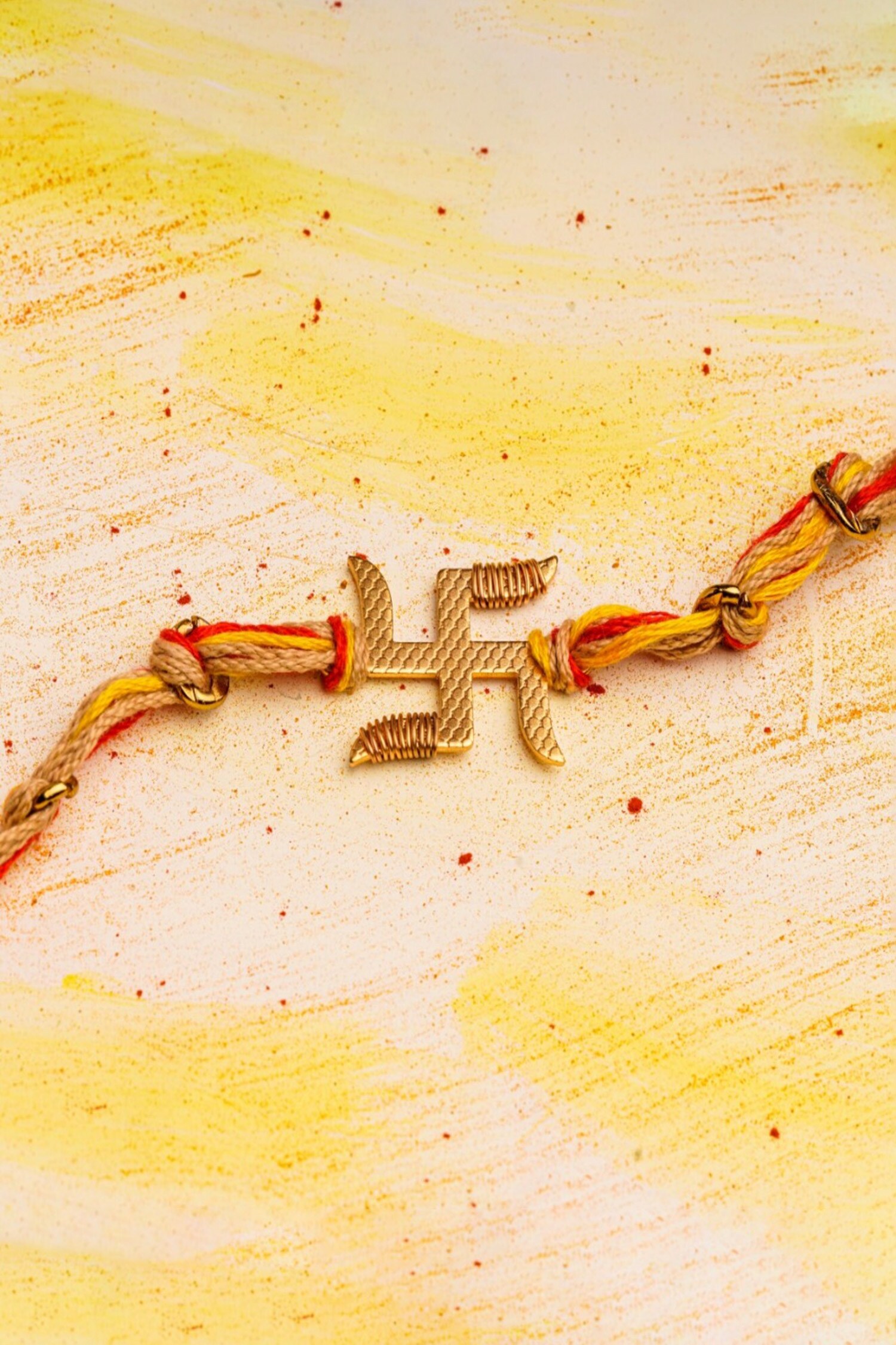 Buy Gold Swastika Motif Rakhi by SUHANI PITTIE Online at Aza Fashions.